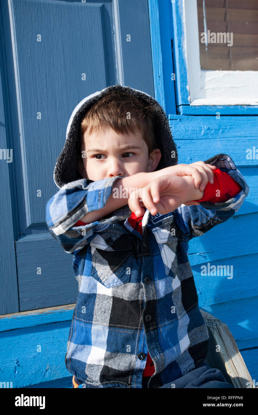 Boy in front of a blue house Stock Photo - Alamy