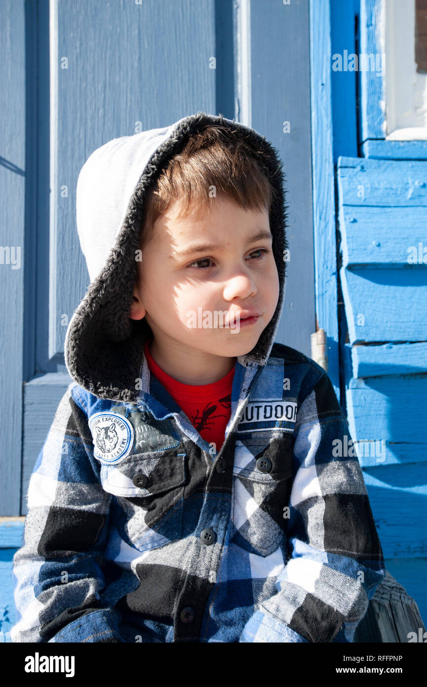 Boy in front of a blue house Stock Photo - Alamy