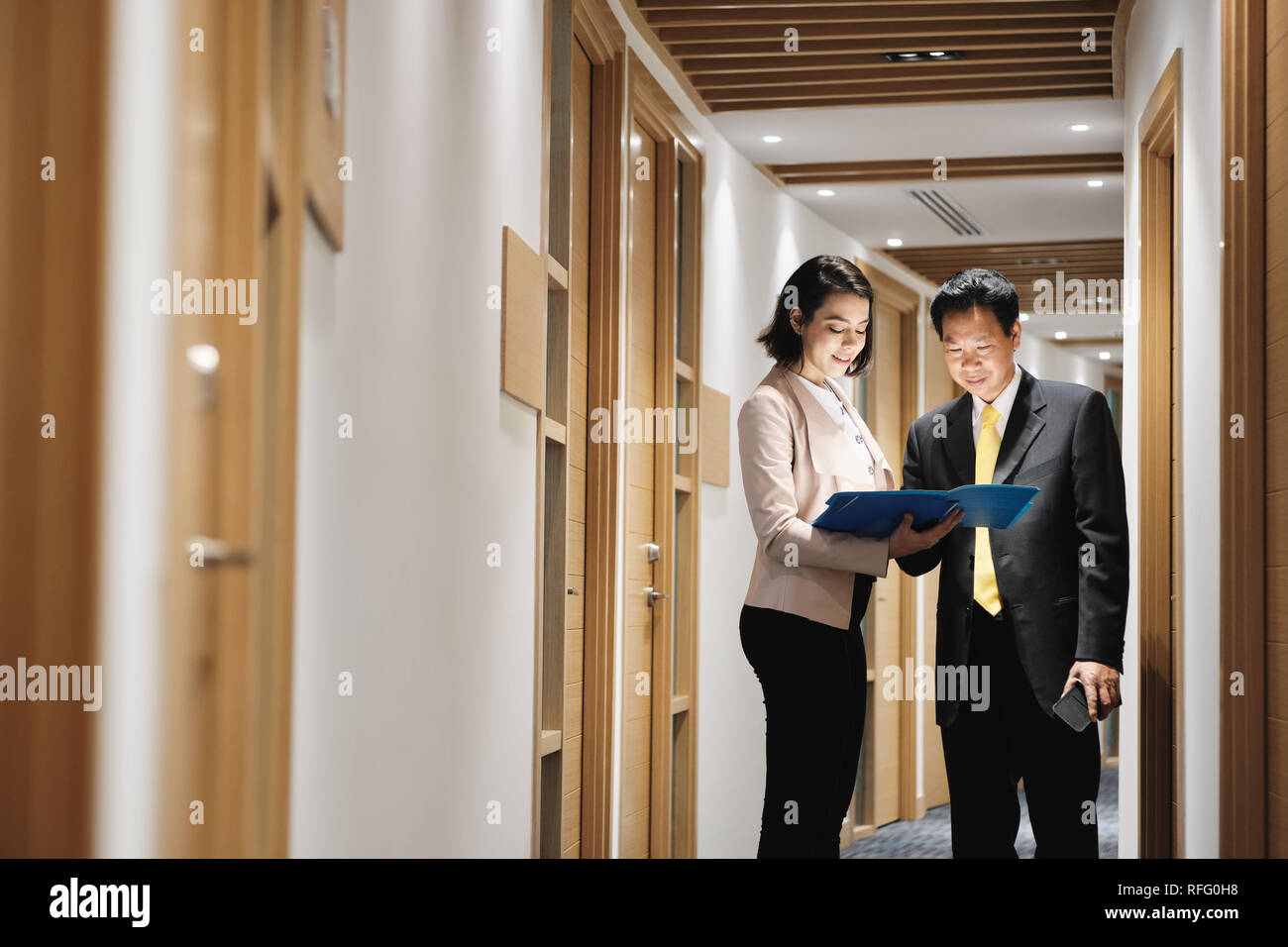 Businesswoman Explaining Documents To Happy Chinese Client In Bank ...