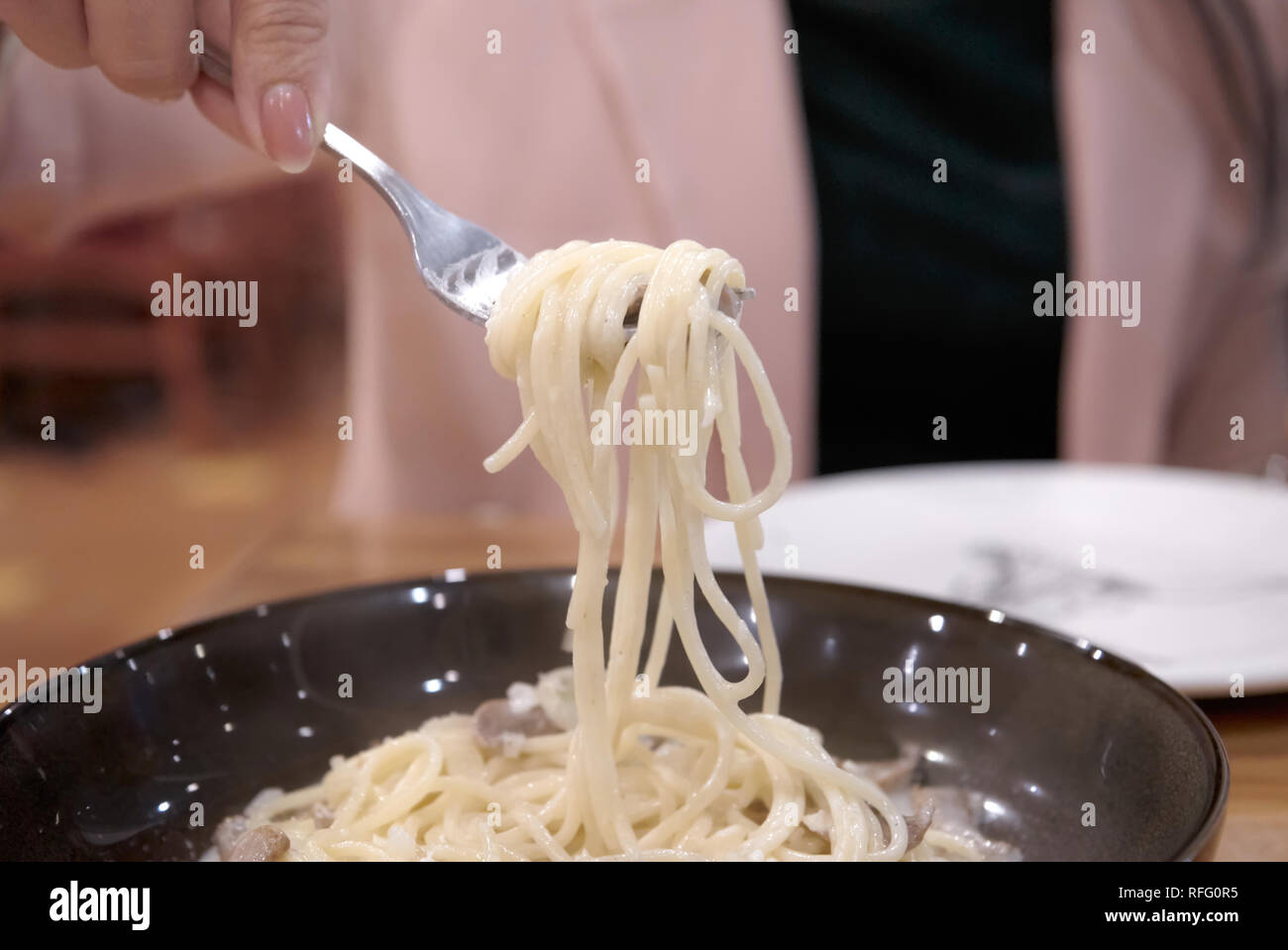 Woman eat pasta hi-res stock photography and images - Alamy