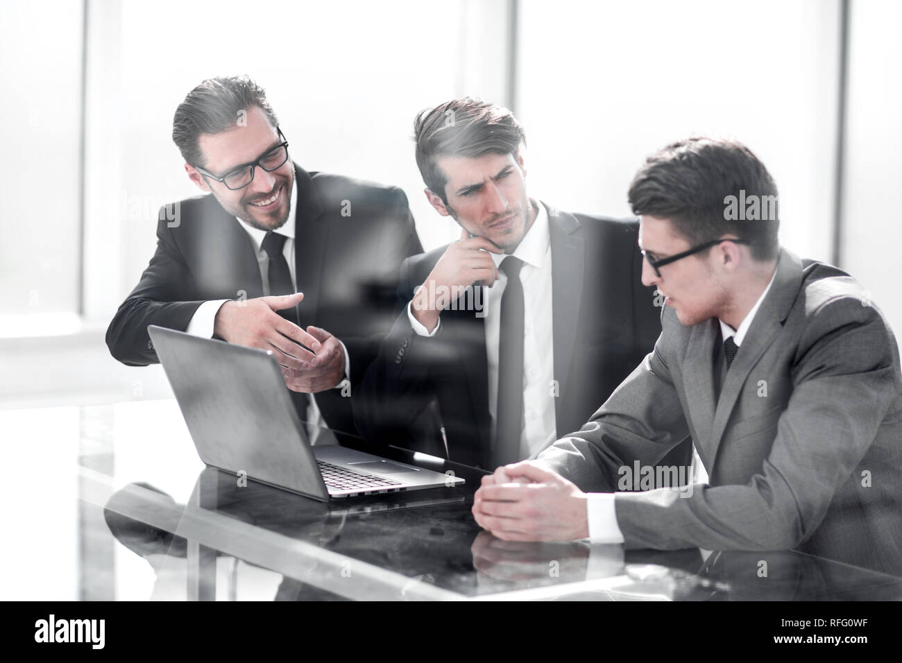 business colleagues using a laptop in the office Stock Photo - Alamy