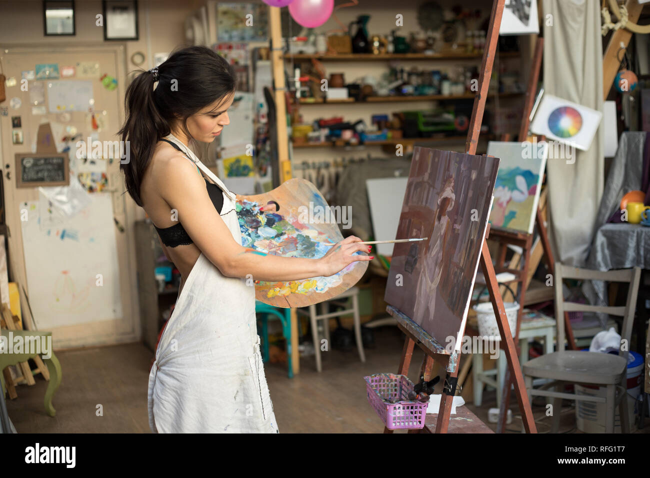 Professional Woman artist painting picture in art studio Stock Photo ...