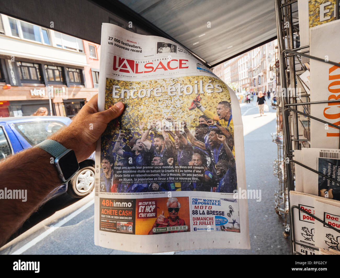 PARIS, FRANCE - JUL 16, 2018: Man buying L'Alsace newspaper announcing ...