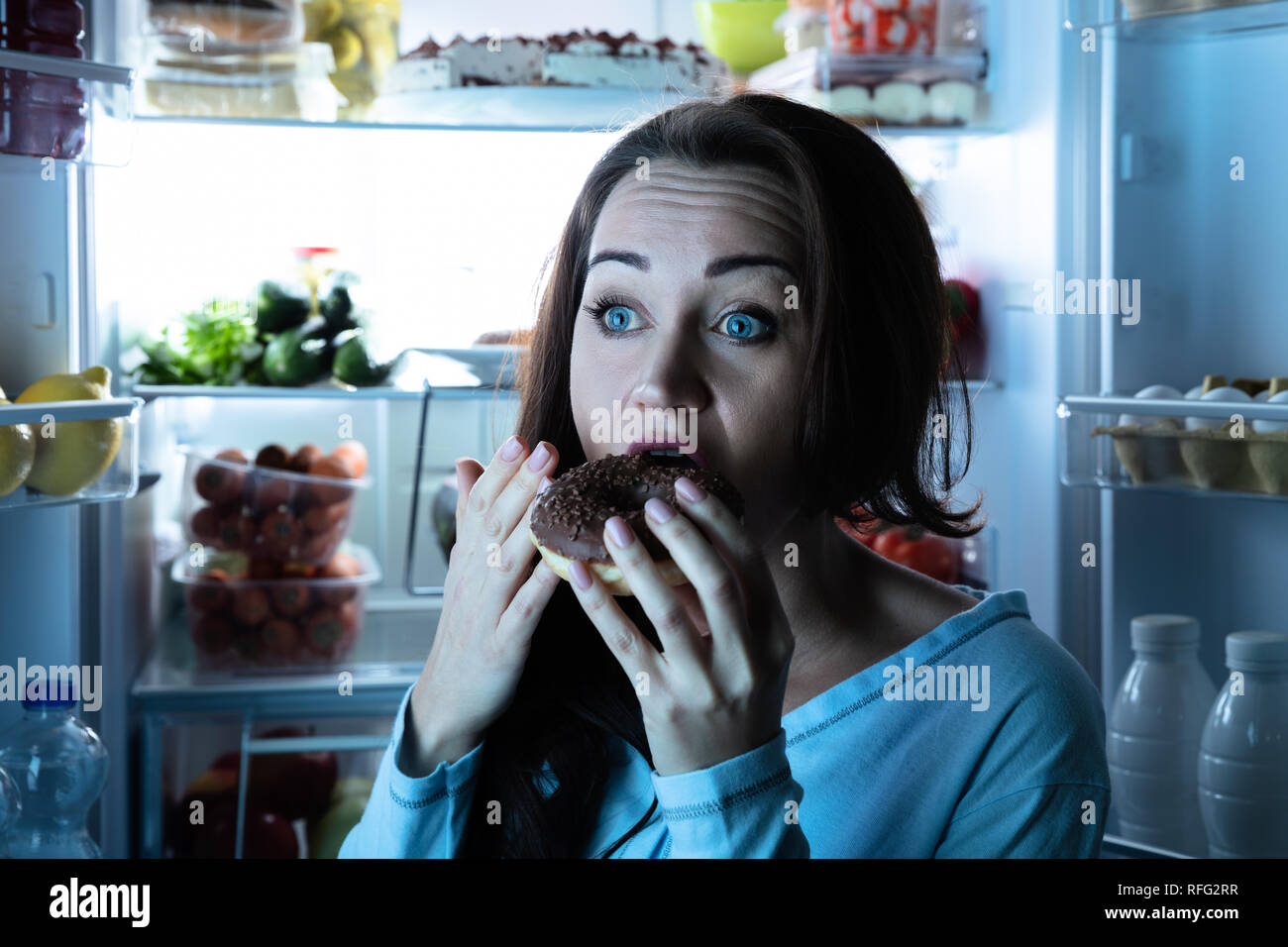 Woman eating donut hi-res stock photography and images - Alamy
