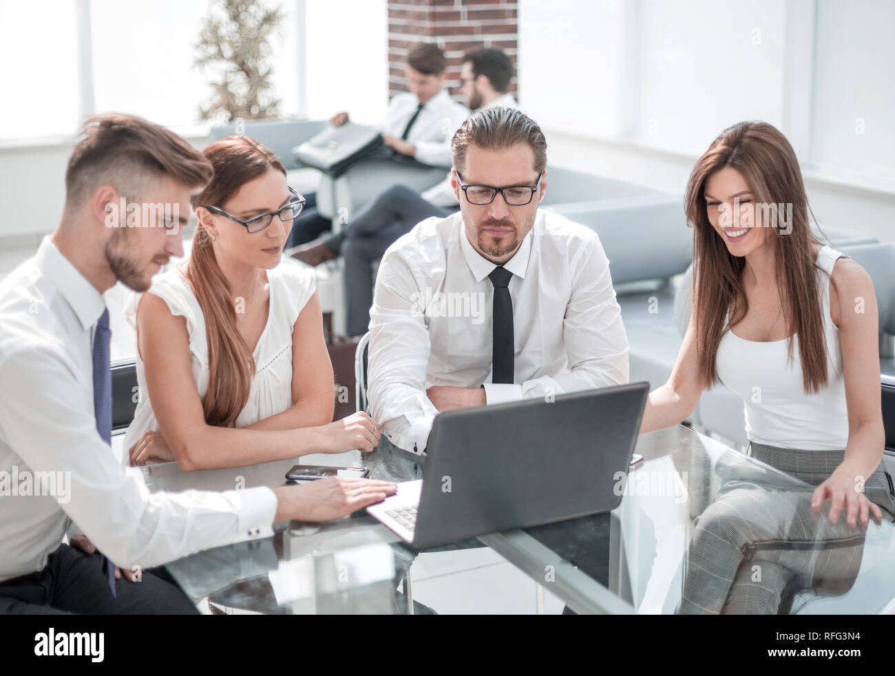 group of business people sitting at the Desk Stock Photo - Alamy