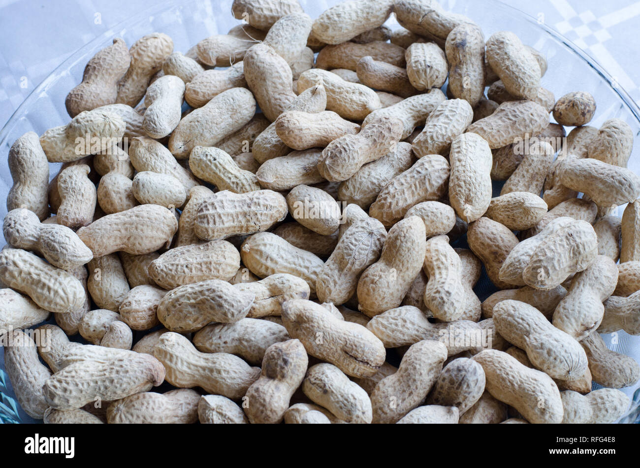 Peanuts in group on a tray of glass on table with silver cloth Stock ...