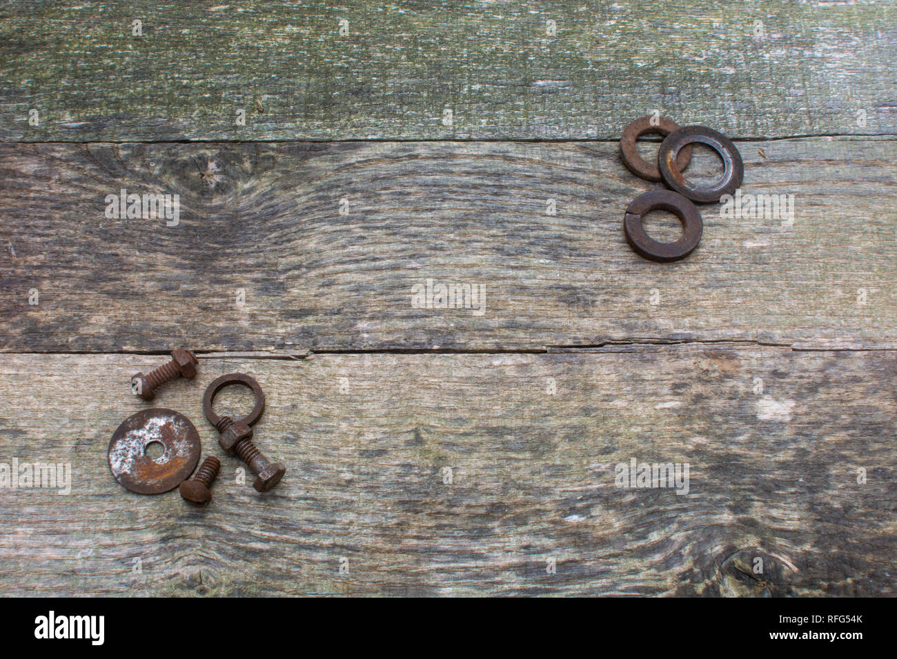 Weathered pallet wood boards as a background with rusty nuts, bolts ...