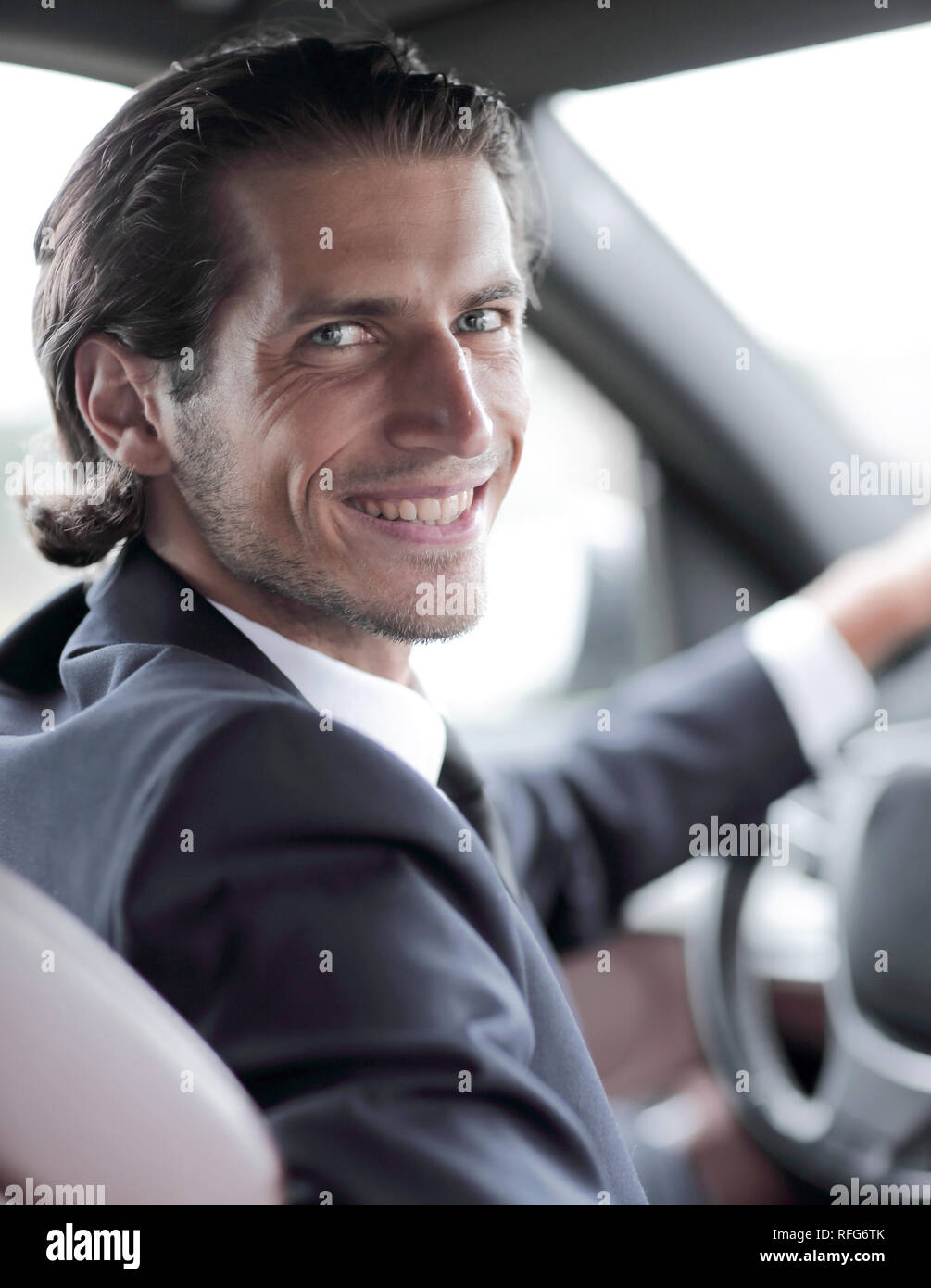 man sitting behind the wheel of a car Stock Photo - Alamy
