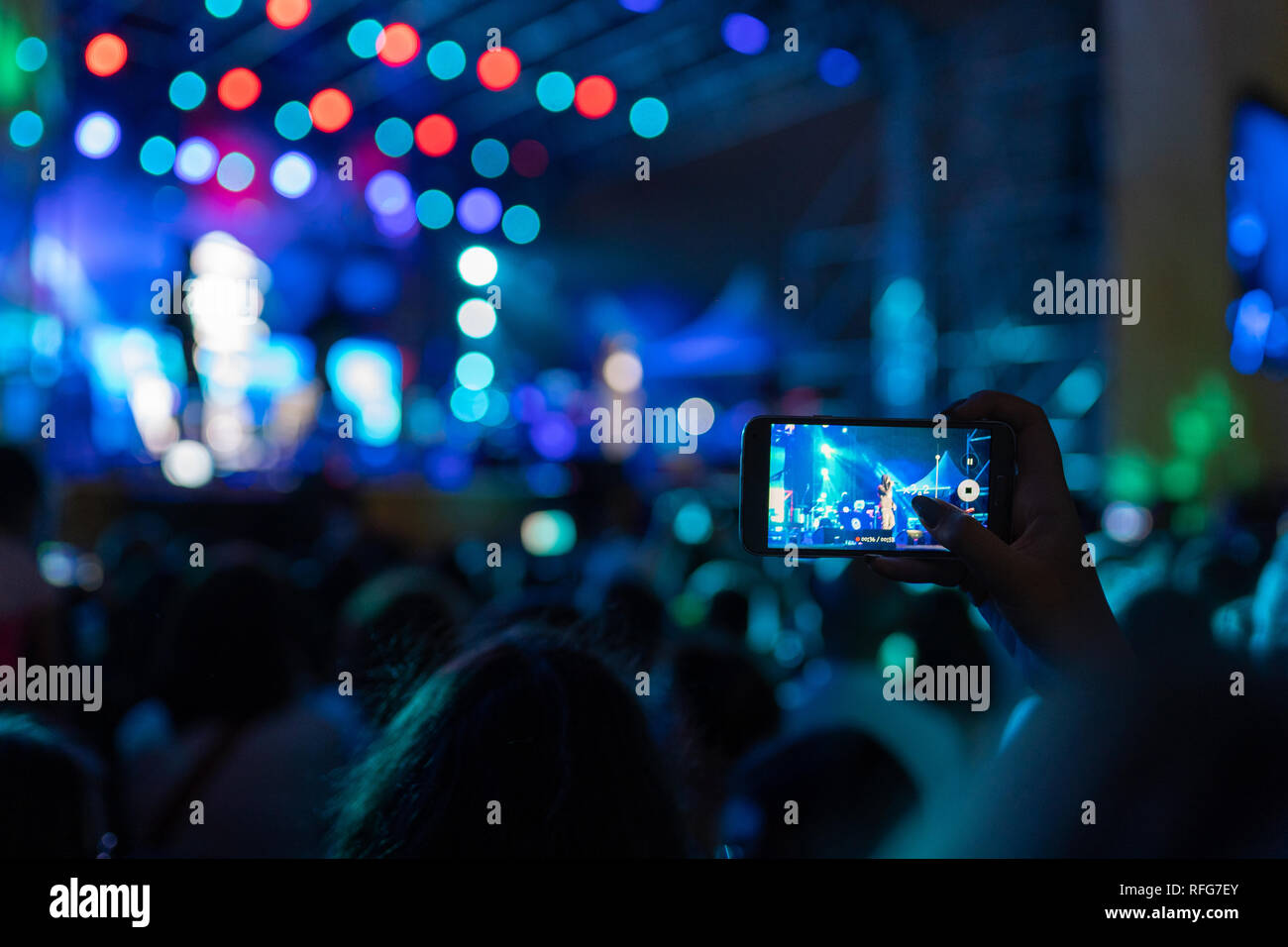 Woman recording event with mobile hi-res stock photography and images ...