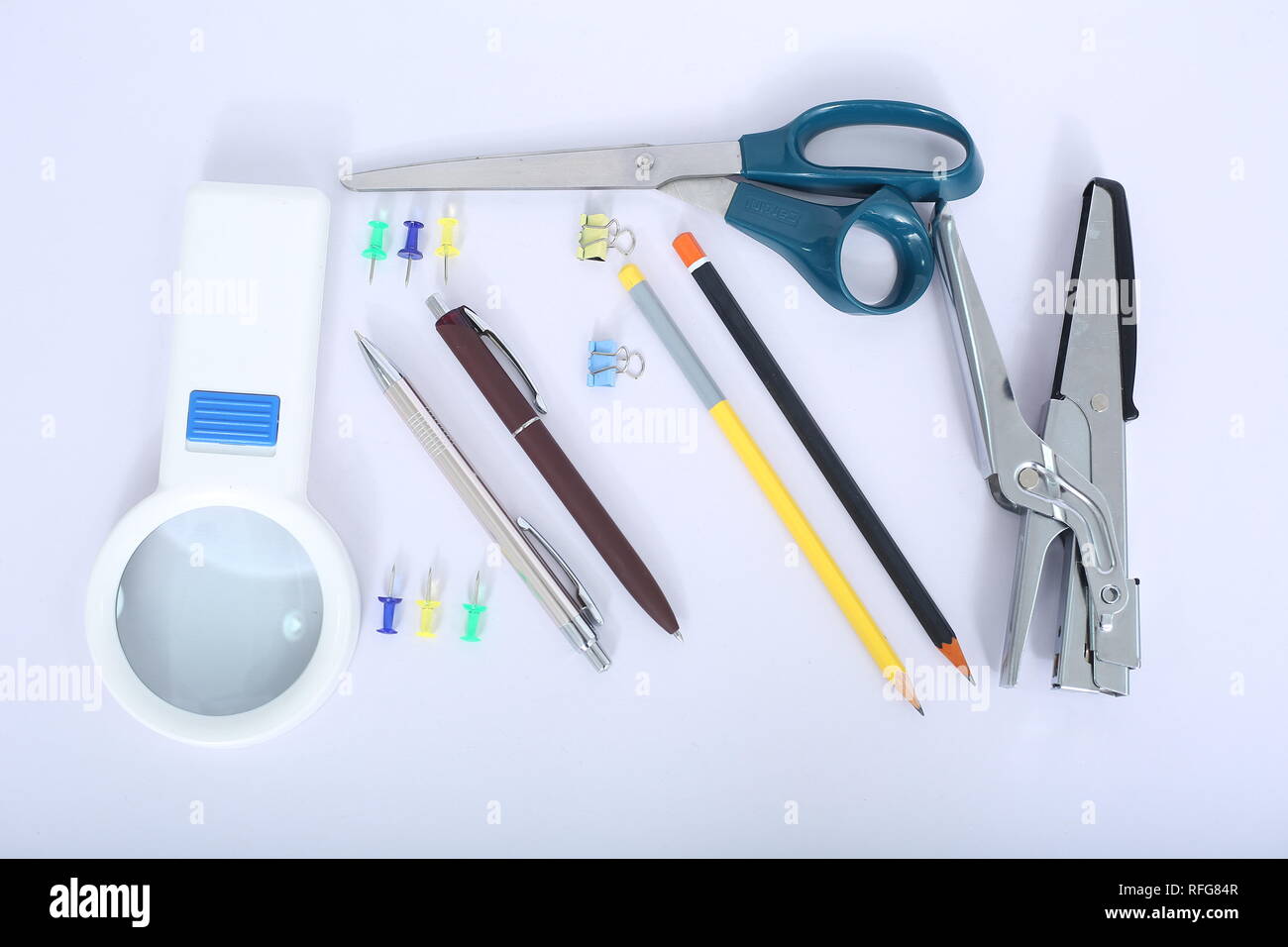 Portrait of ball pen, stapler, pencil, scissor, paper clip and ...