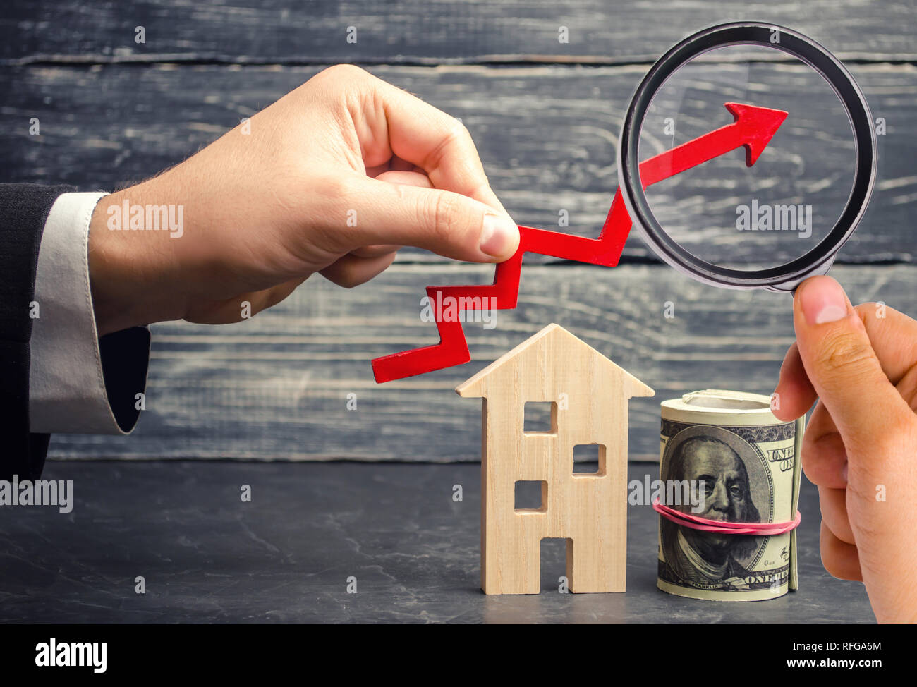 Wooden house with a red arrow up. concept of high demand for real ...