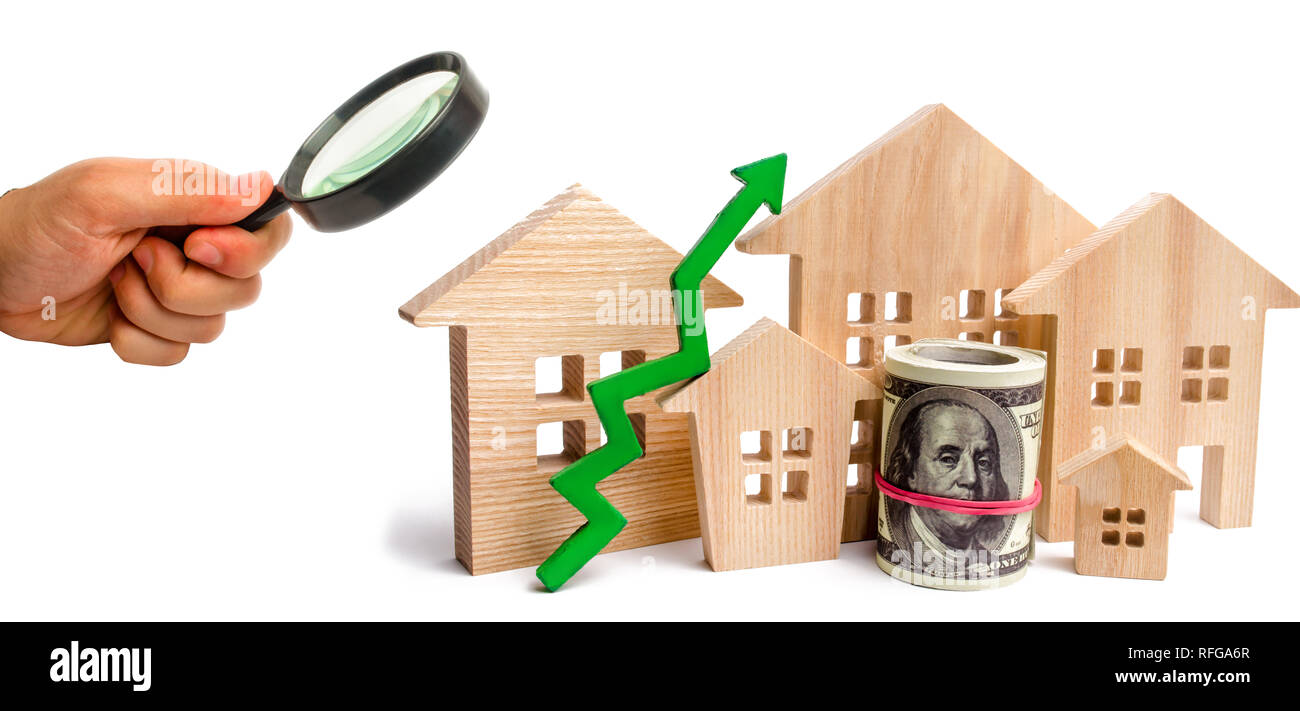 Wooden houses with a green arrow up. concept of high demand for real ...