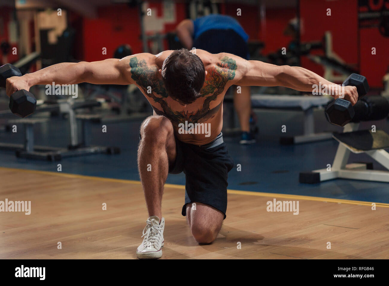 Very fit man with low body fat in the gym doing exercise Stock Photo ...