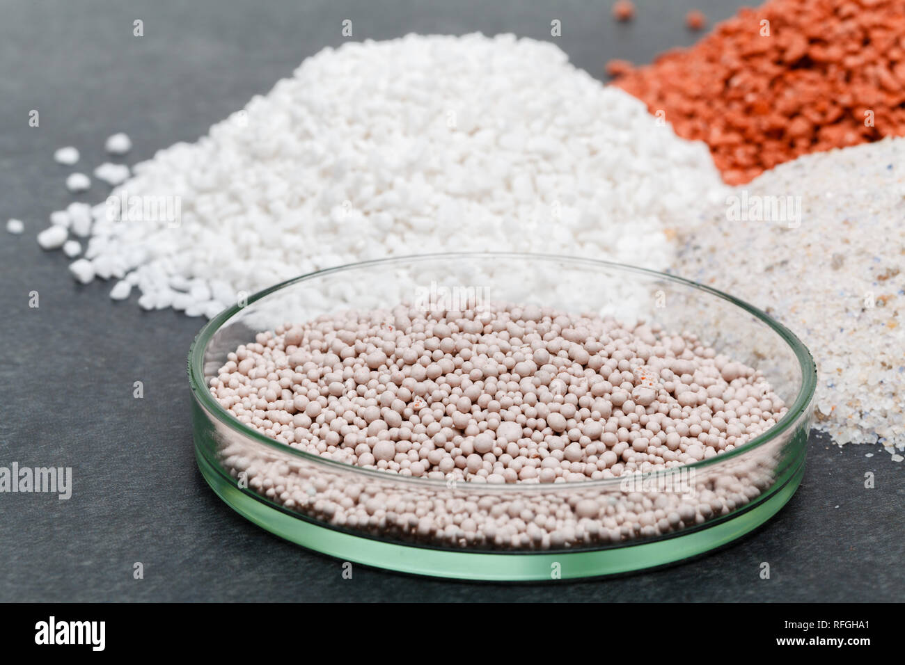 Chemical fertilizer on soil background Stock Photo - Alamy