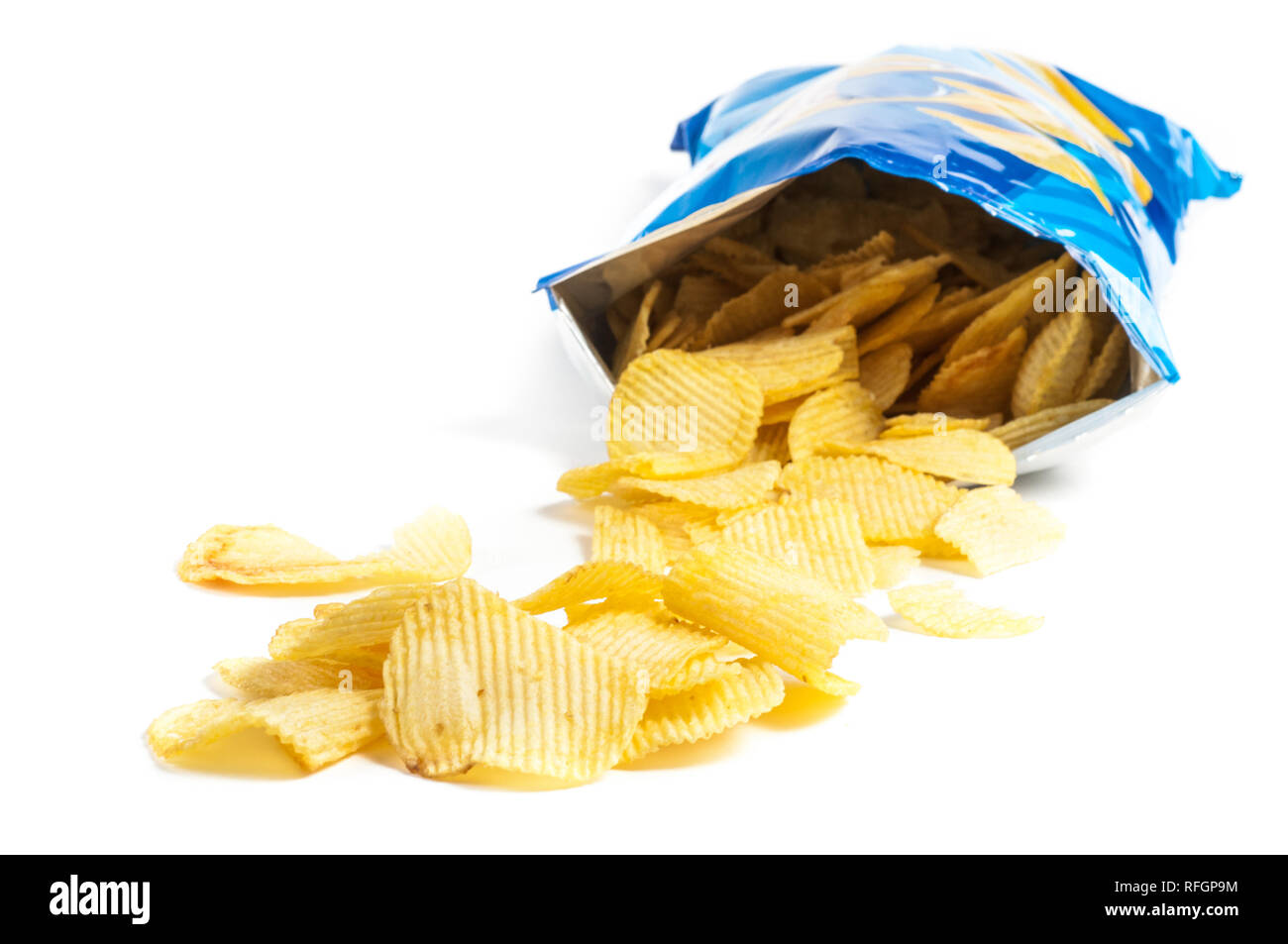 heap of potato crisps on white background, blue and yellow package ...