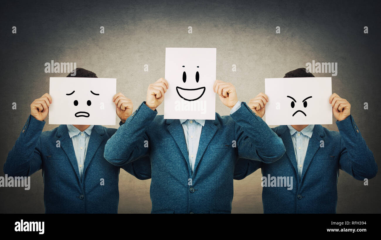 Man cover face using paper with emotions sketch, like hiding mask ...