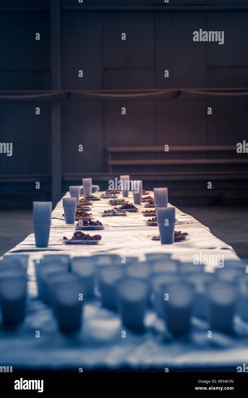Snacks for drinking beer. Long table served with plastic cups and ...