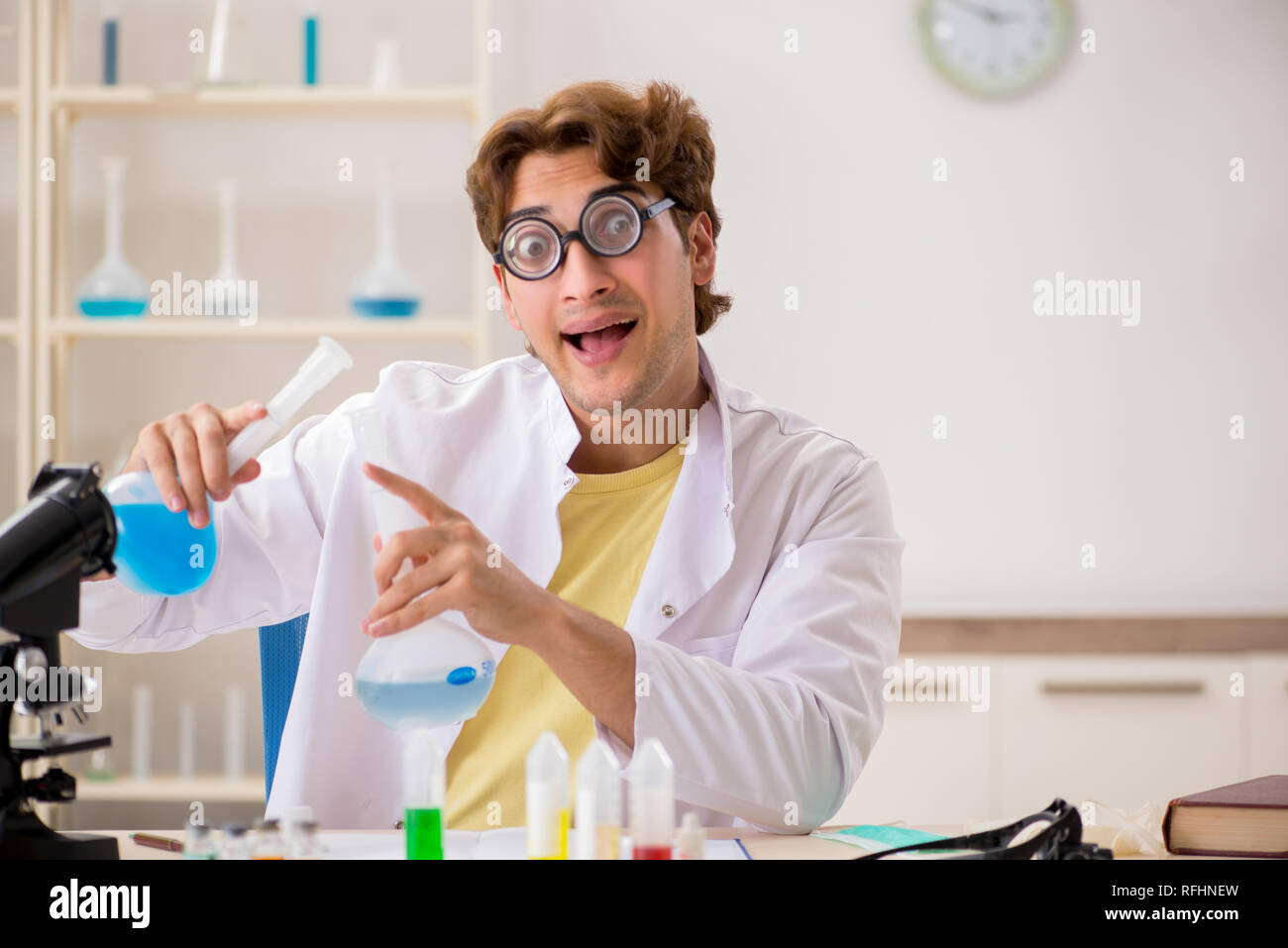 Funny crazy chemist doing experiments and tests Stock Photo - Alamy