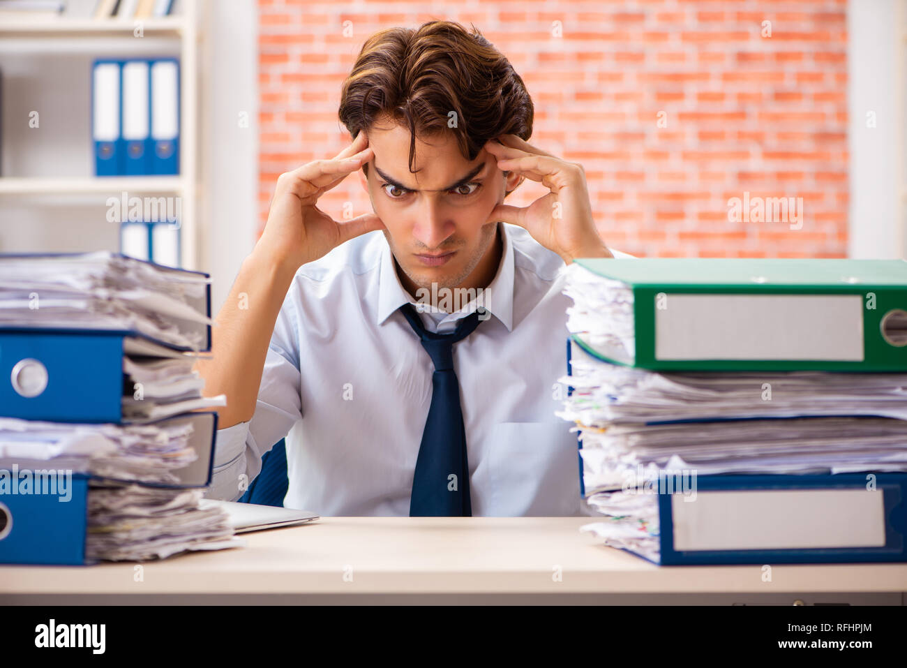 Young elegant man unhappy with too much work Stock Photo - Alamy