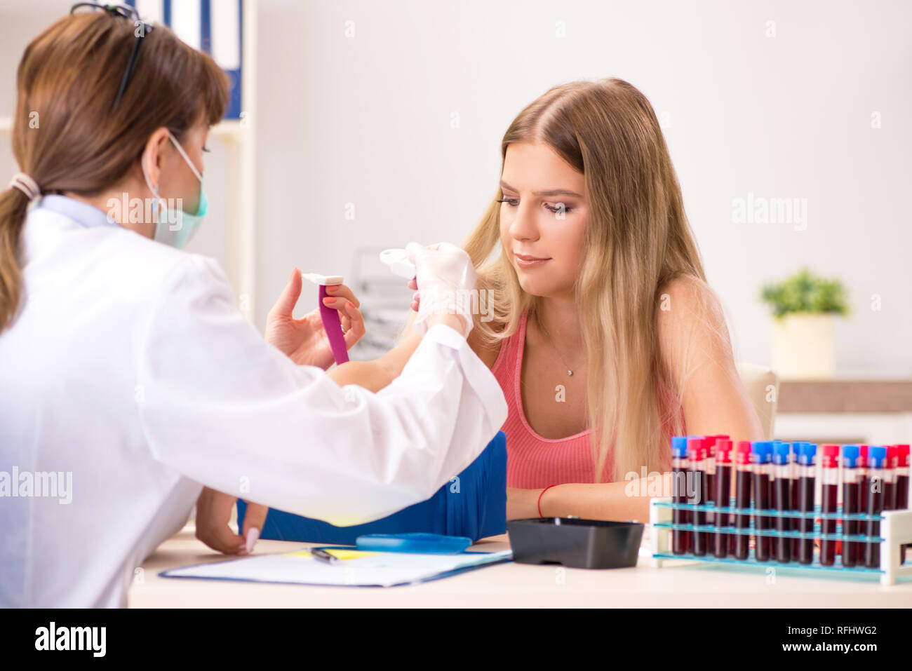 Young beautiful woman during blood test sampling procedure Stock Photo ...