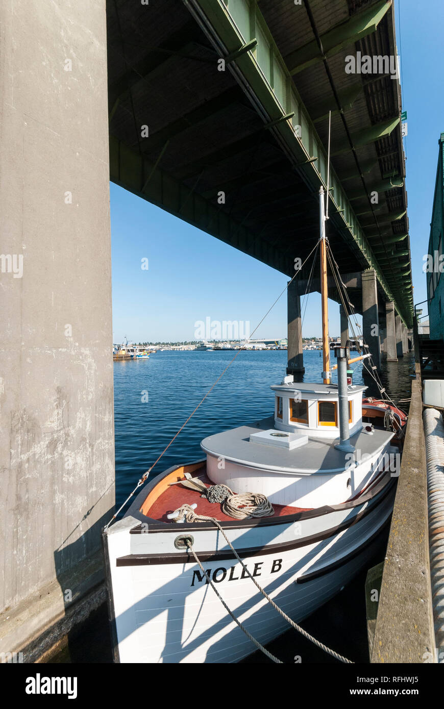 A boat is moored under a bridge in Ballard, Washington Stock Photo - Alamy