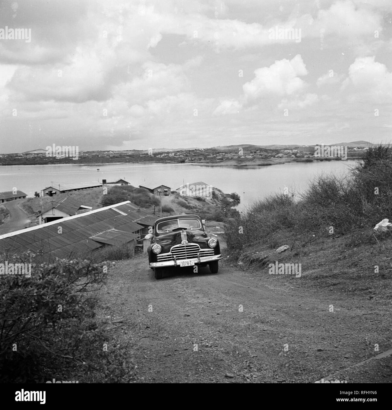 Auto op een weg op Curaçao Op de achtergrond het Schottegat ...