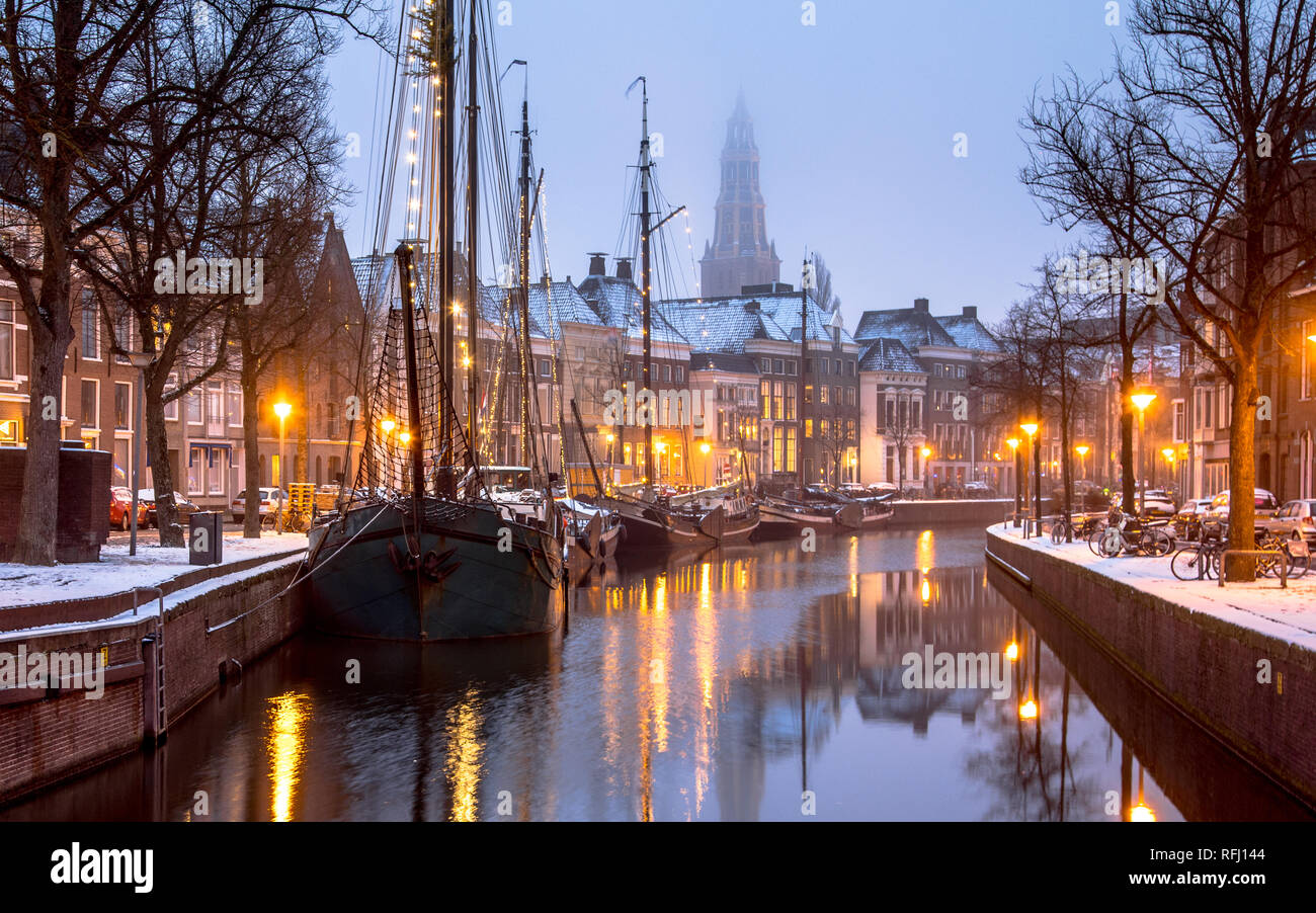 Historic sailing ships covered in snow at Hoge der Aa quay on ...