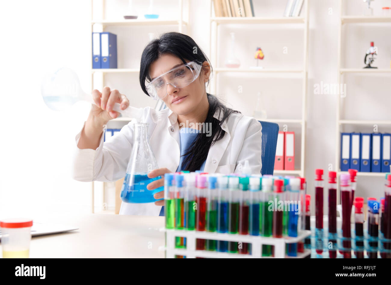 Female chemist working at the lab Stock Photo - Alamy