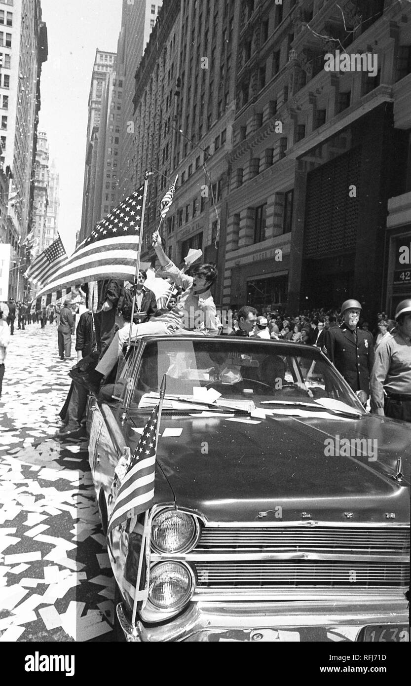 Demonstrators march and hold banners and American flags on a Plymouth ...