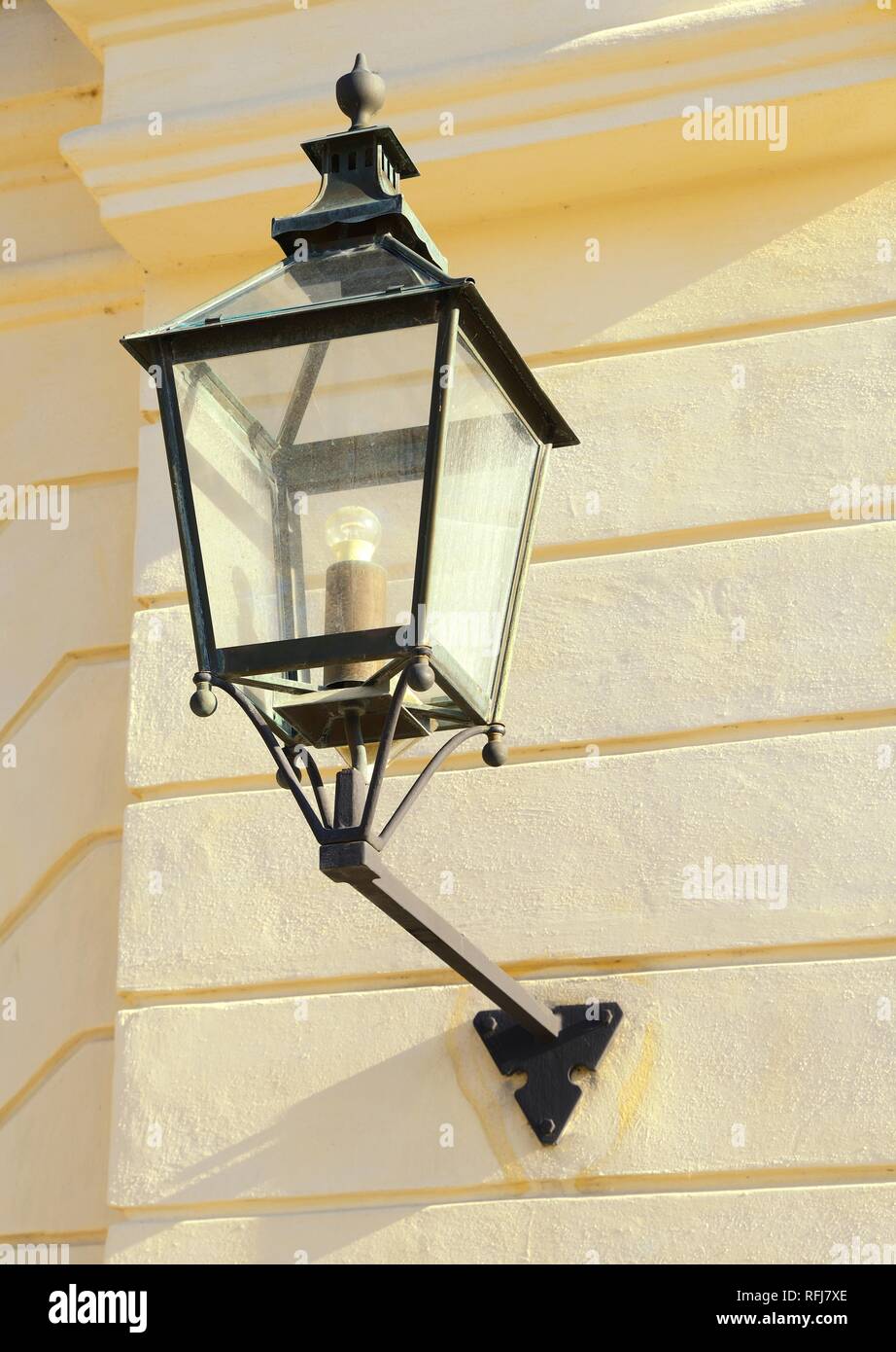 The street lamp is built into the wall of the building Stock Photo - Alamy