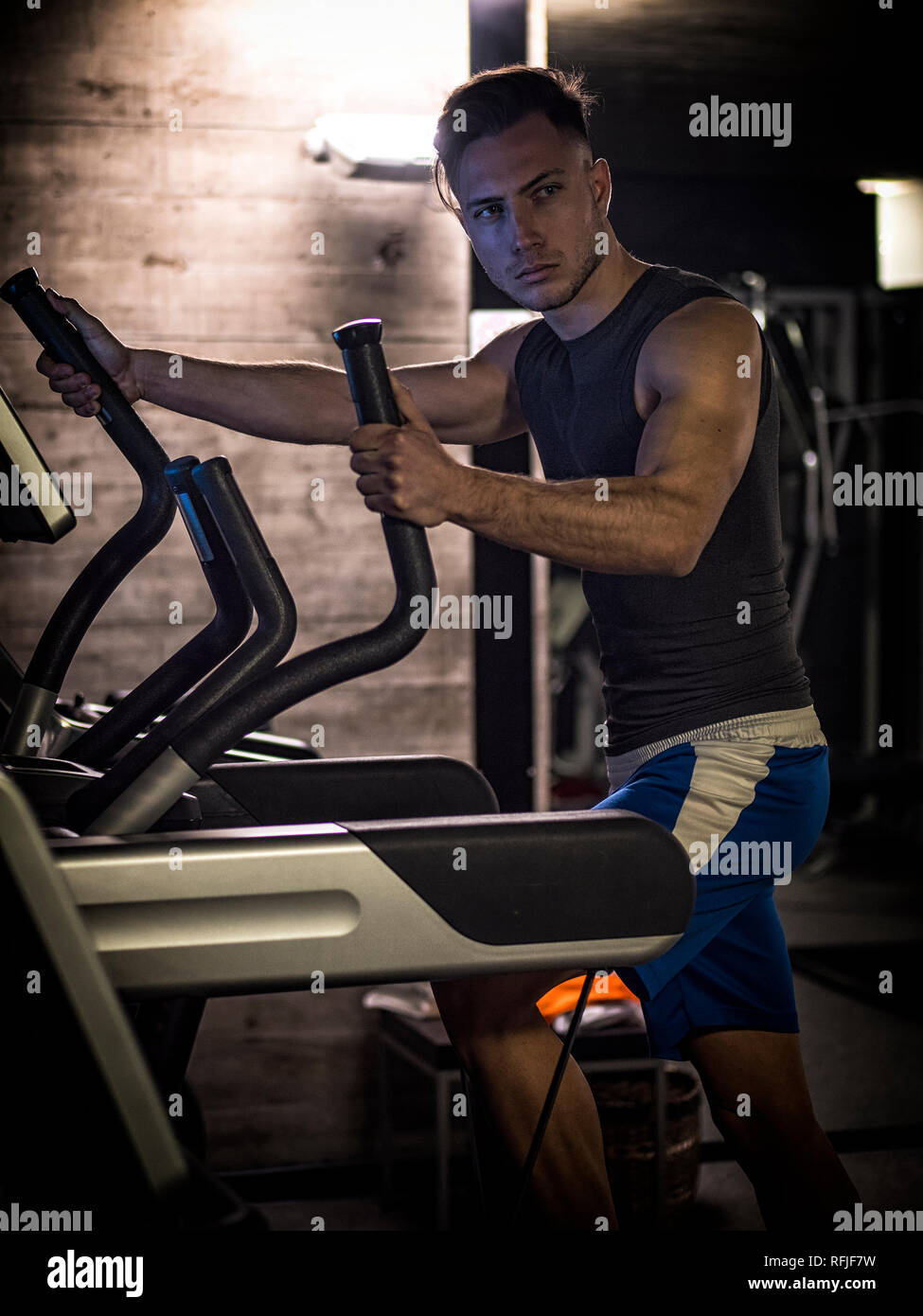 Muscular young man, training pecs on gym machine Stock Photo - Alamy