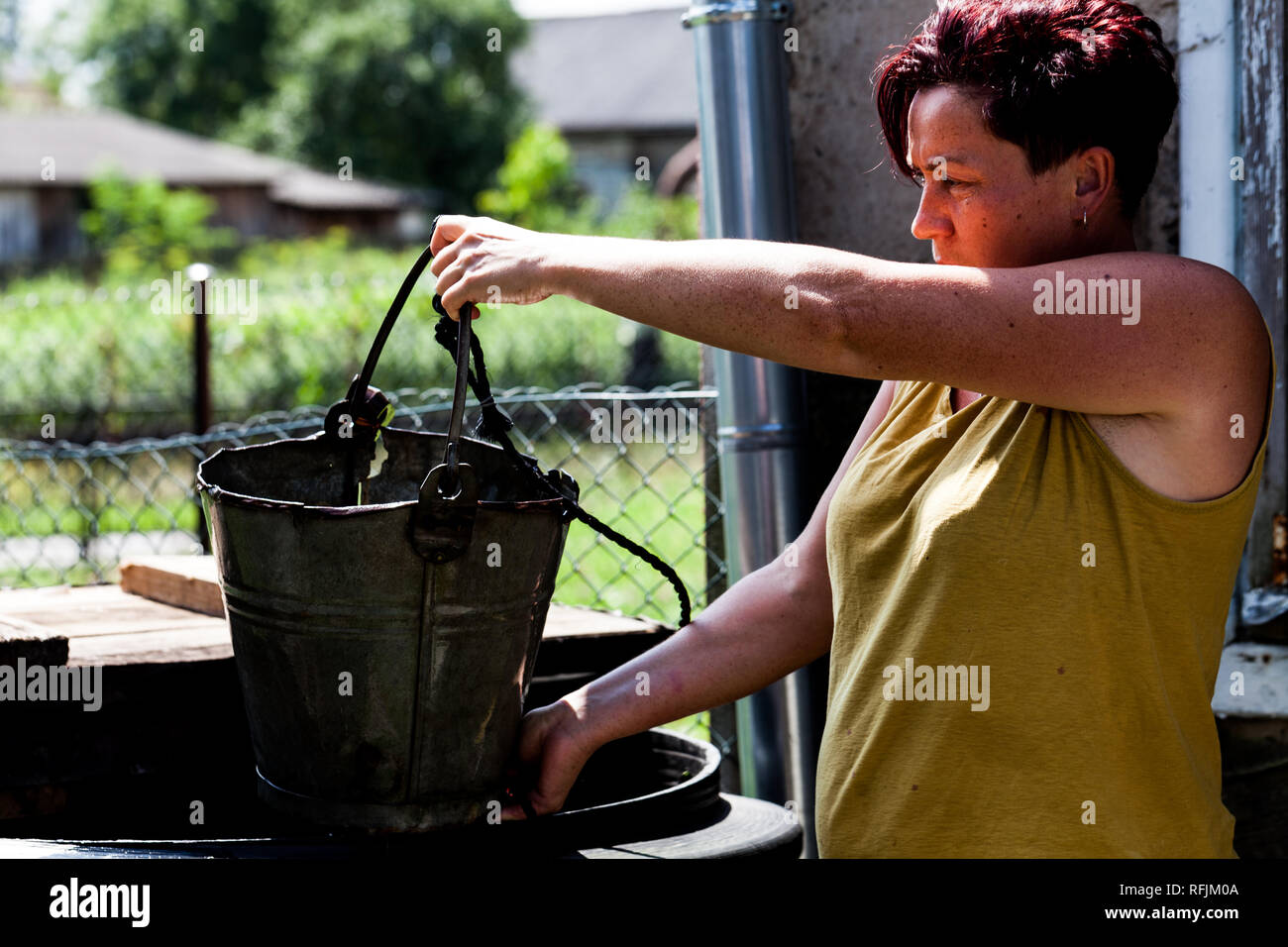 Woman fetching water from well hi-res stock photography and images - Alamy