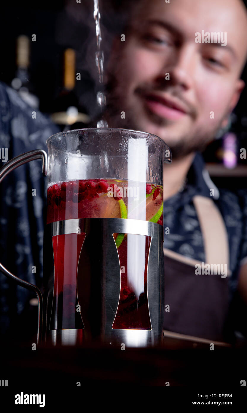 Process brewing tea,tea ceremony. Bartender pours hot water into the ...