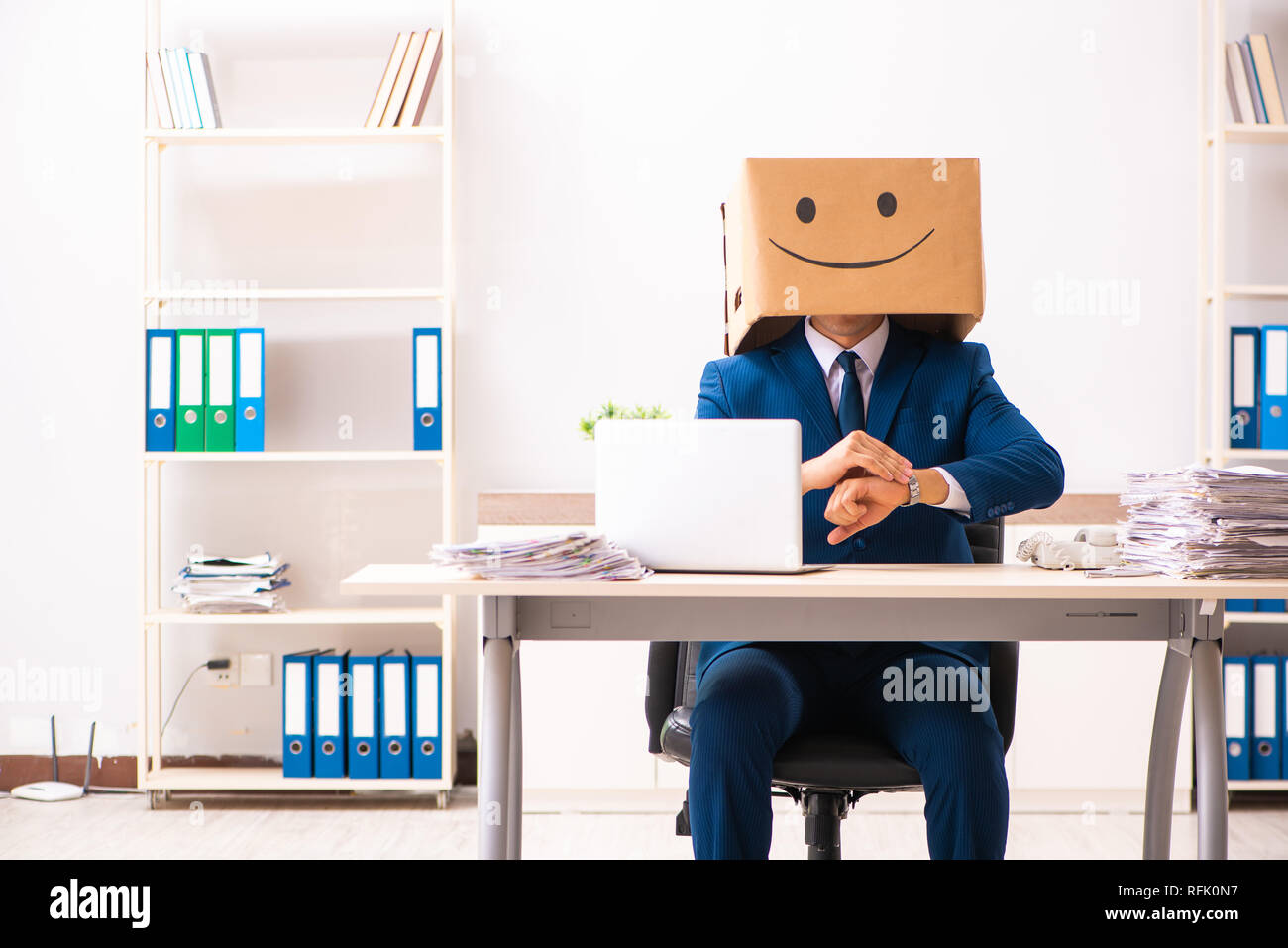 Happy man employee with box instead of his head Stock Photo - Alamy