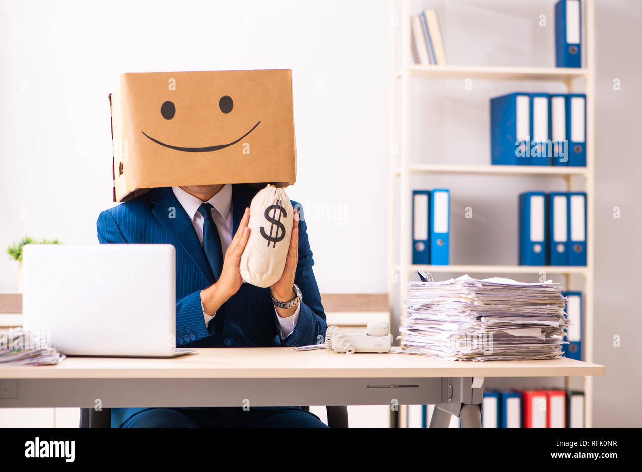 Happy man employee with box instead of his head Stock Photo - Alamy