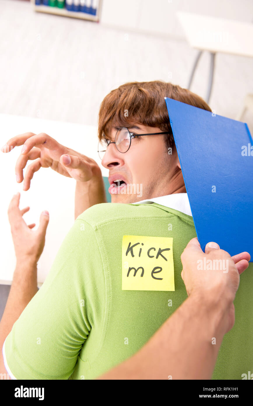 Office prank with kick me message on sticky note Stock Photo - Alamy
