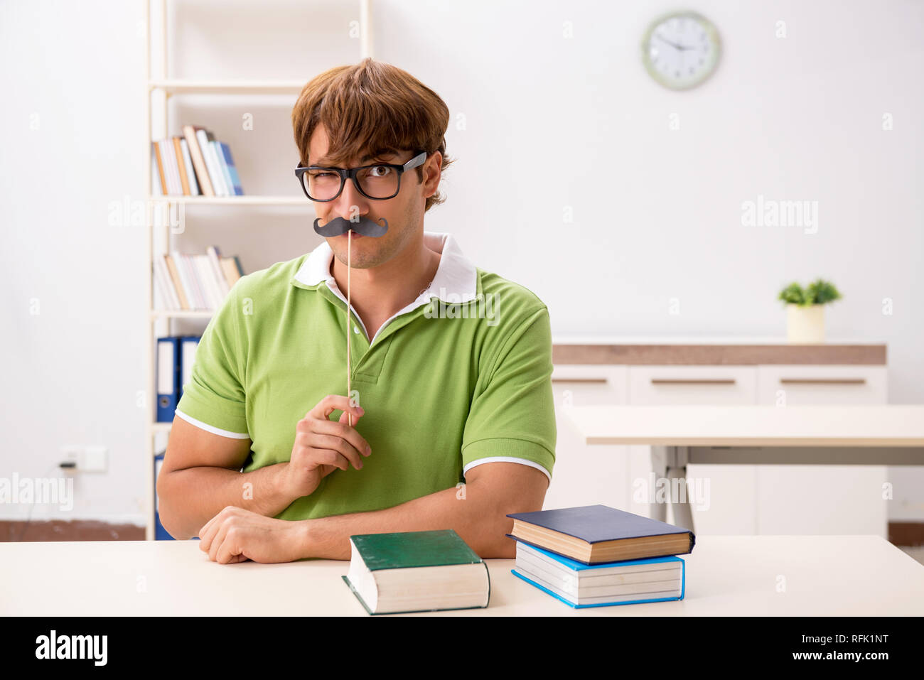 Student with fake moustache reading book Stock Photo - Alamy