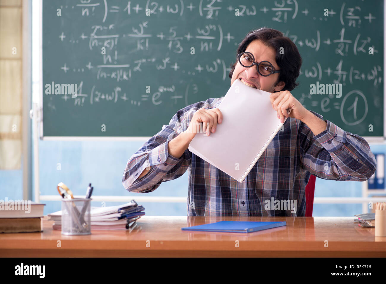 Young funny math teacher in front of chalkboard Stock Photo - Alamy