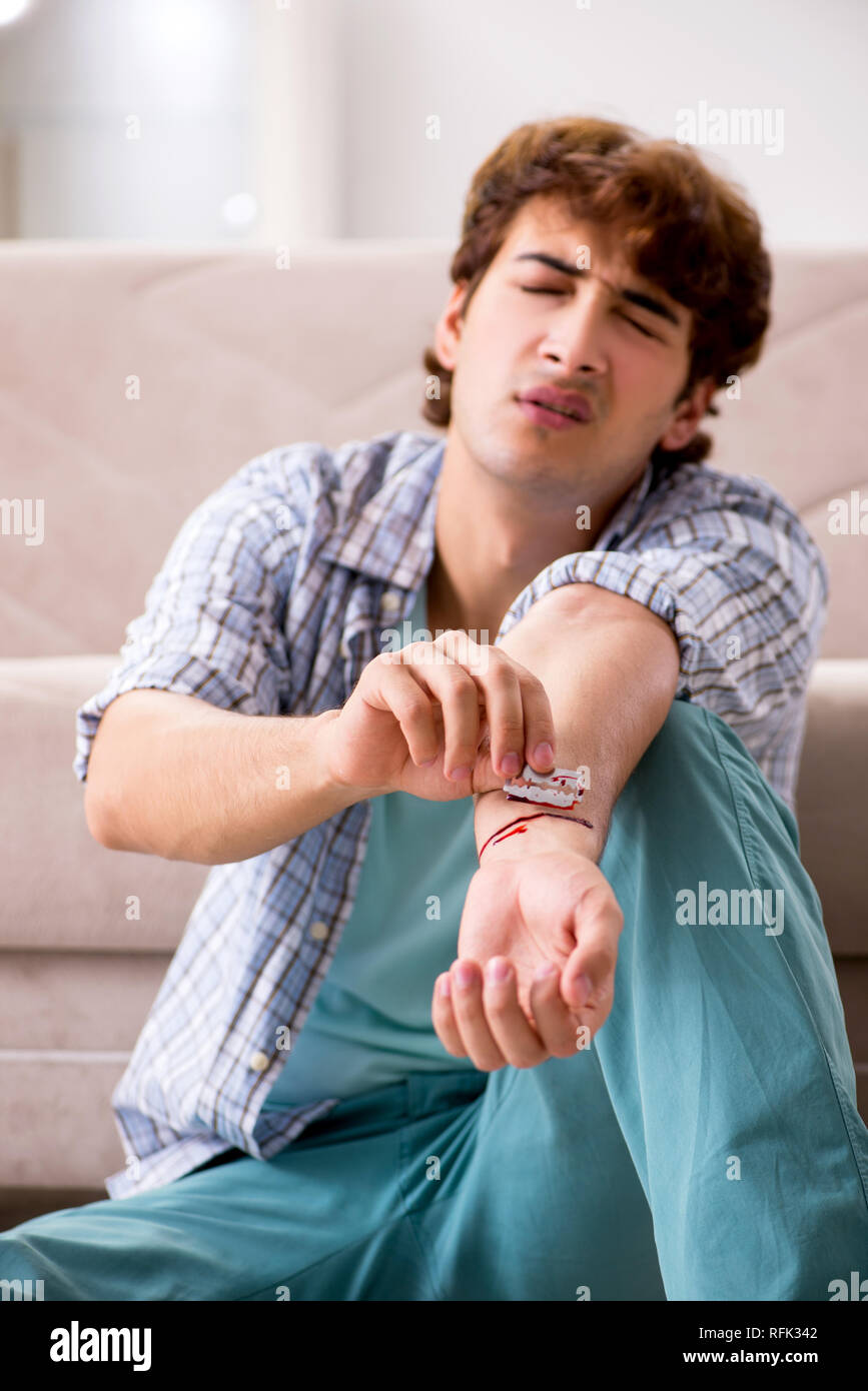 Young man committing suicide with razor blade Stock Photo - Alamy
