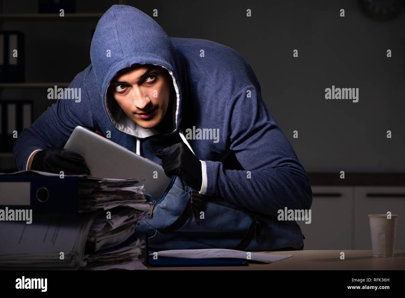 Thief trying to steal personal data in identity theft concept Stock ...