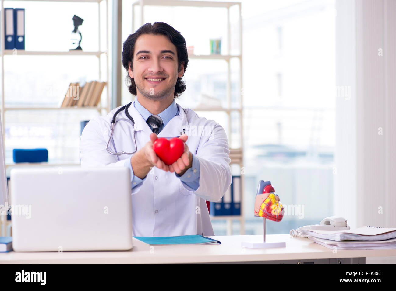 Young handsome doctor cardiologist in front of whiteboard Stock Photo ...