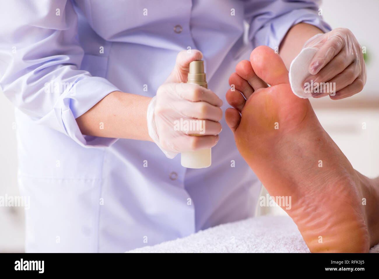 Podiatrist treating feet during procedure Stock Photo - Alamy