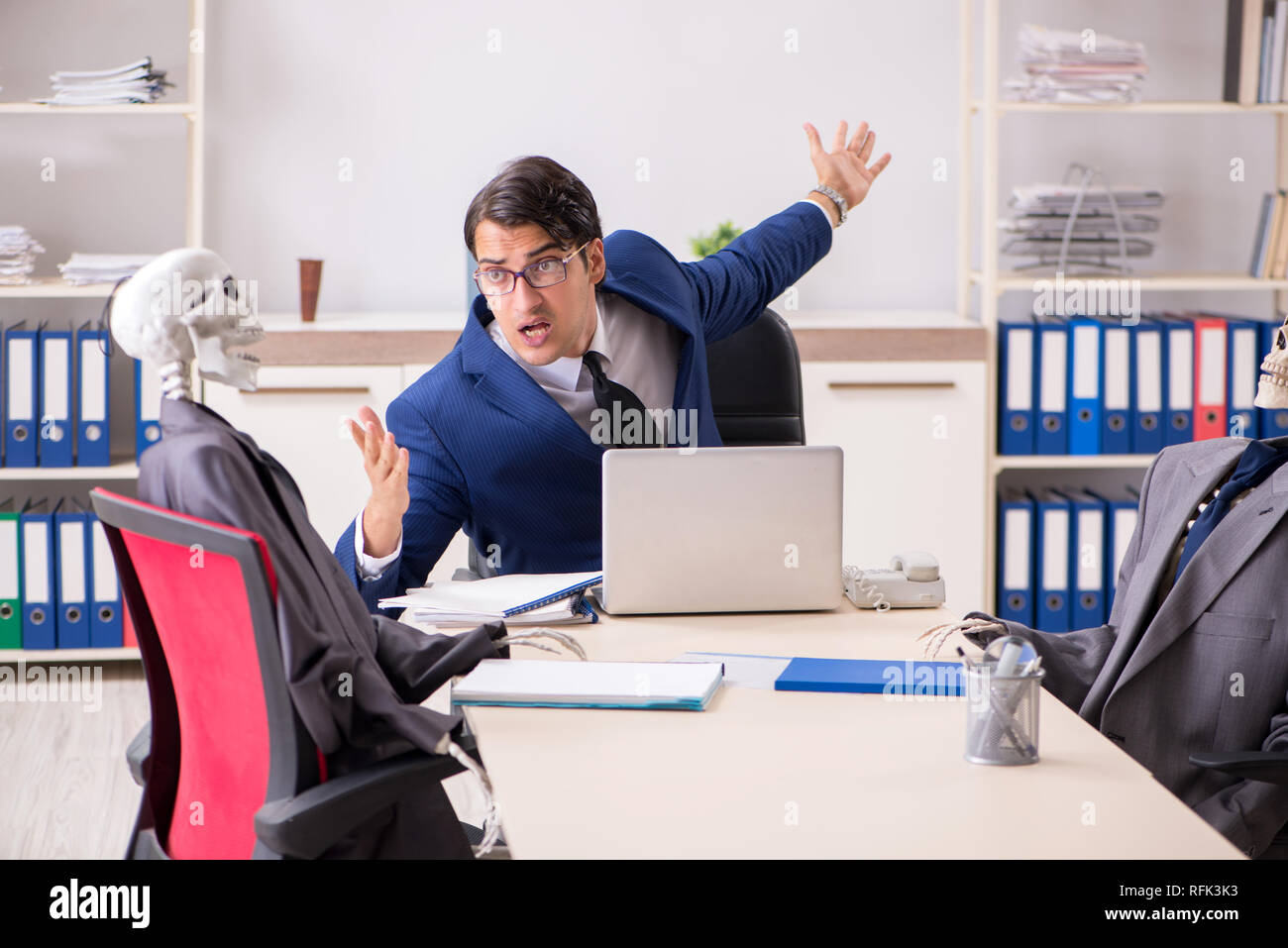 Funny business meeting with boss and skeletons Stock Photo - Alamy