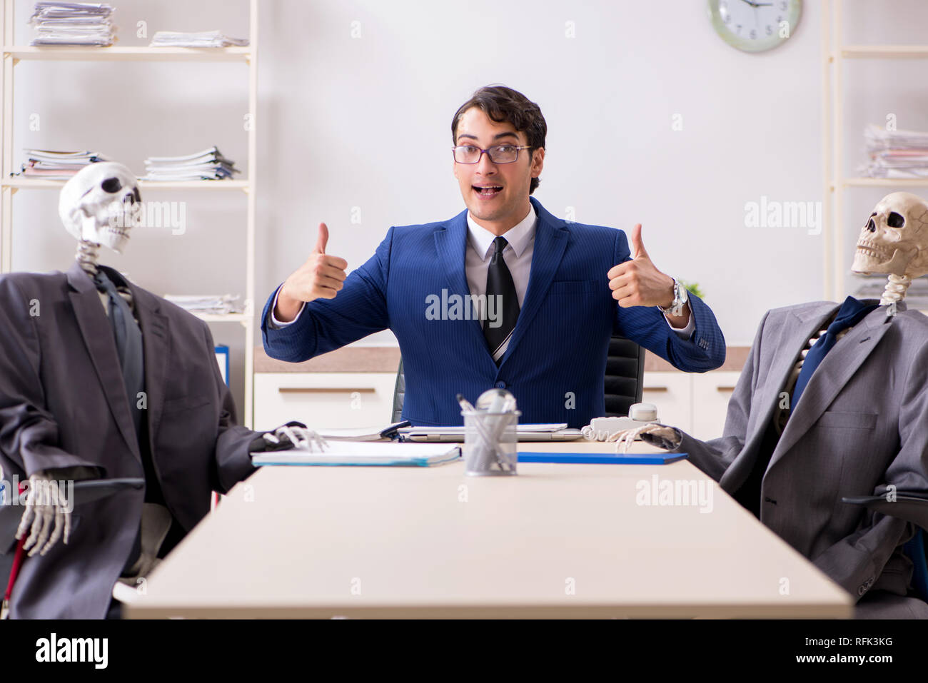 Funny business meeting with boss and skeletons Stock Photo - Alamy