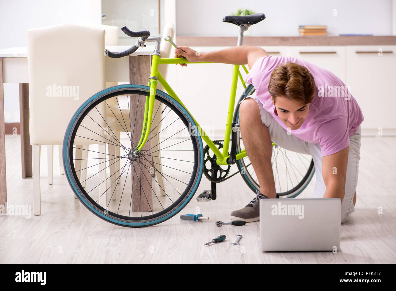 Man repairing his broken bicycle Stock Photo - Alamy