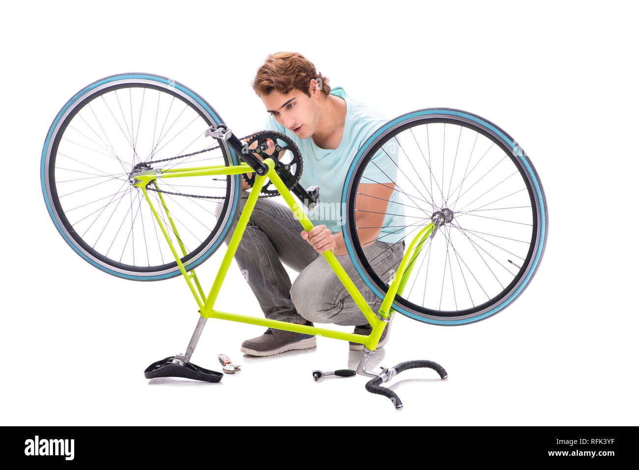 Man repairing his bike isolated on white background Stock Photo - Alamy