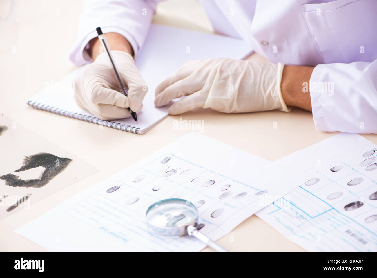 Forensic expert studying fingerprints in the lab Stock Photo - Alamy
