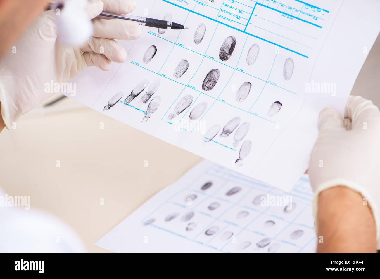 Forensic expert studying fingerprints in the lab Stock Photo - Alamy