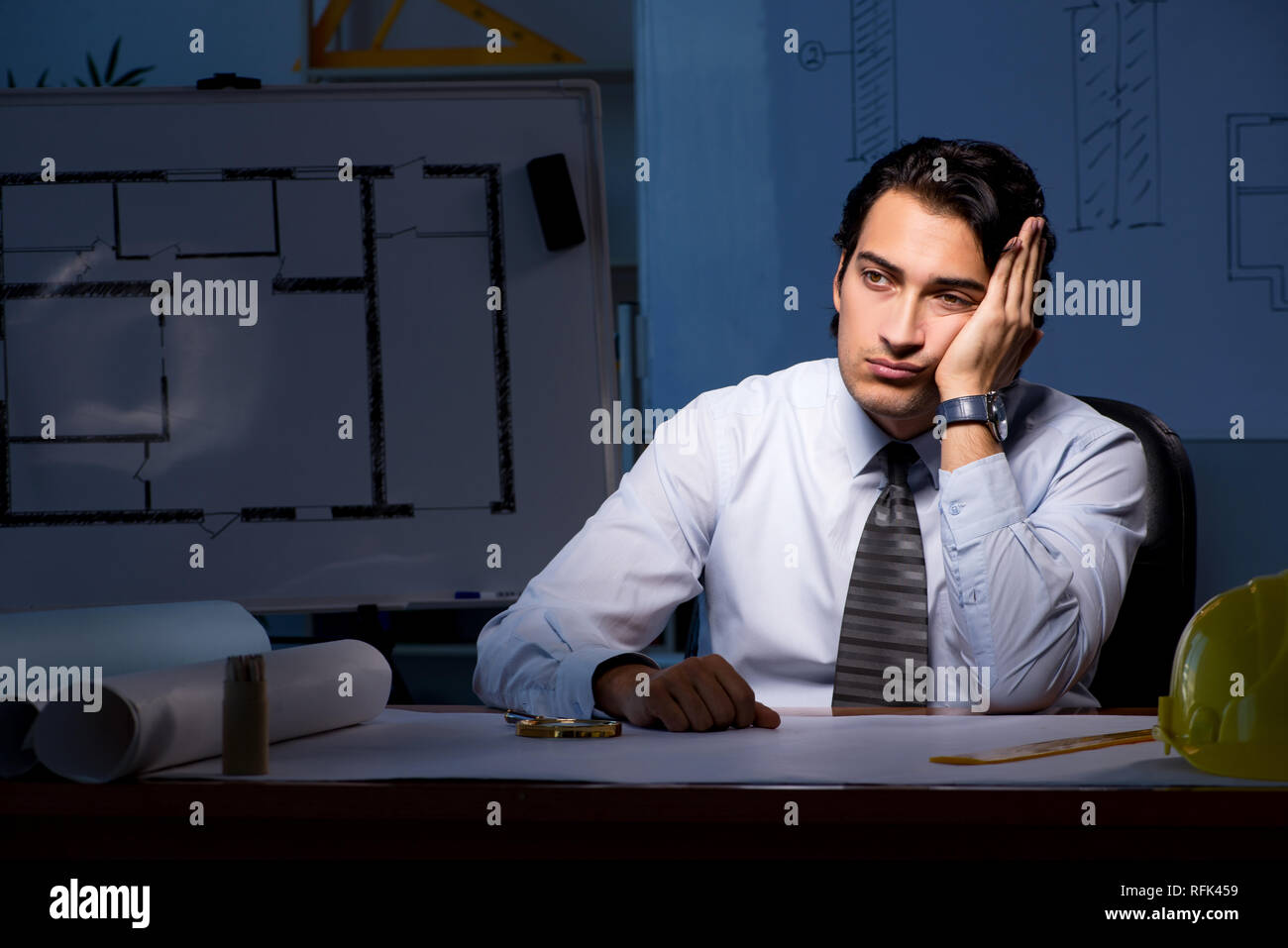 Young construction architect working on project at night Stock Photo ...