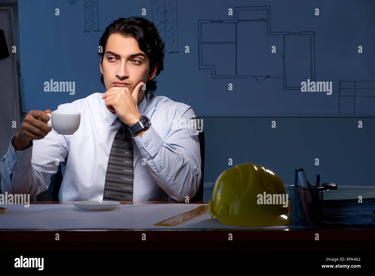 Young construction architect working on project at night Stock Photo ...